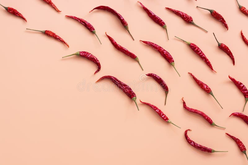 Pattern Dried Red Chili Peppers on a Pastel Pink Background. Top View ...