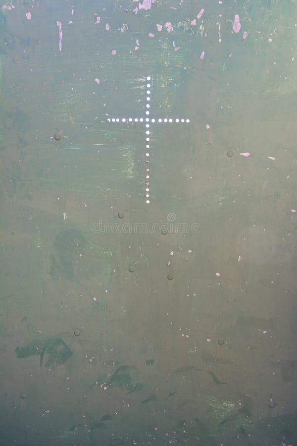 Pattern of Illuminated Holes Forming a Cross on Distressed Green Metal ...