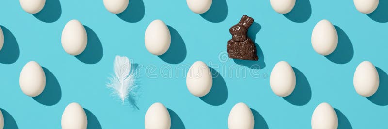 Pattern Made of White Eggs, Chocolate Banny and Bird Feather on Blue ...