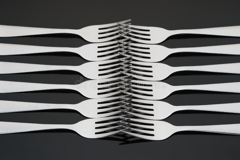 Pattern with Many Silver Forks on Black Mirror Background. Concept ...