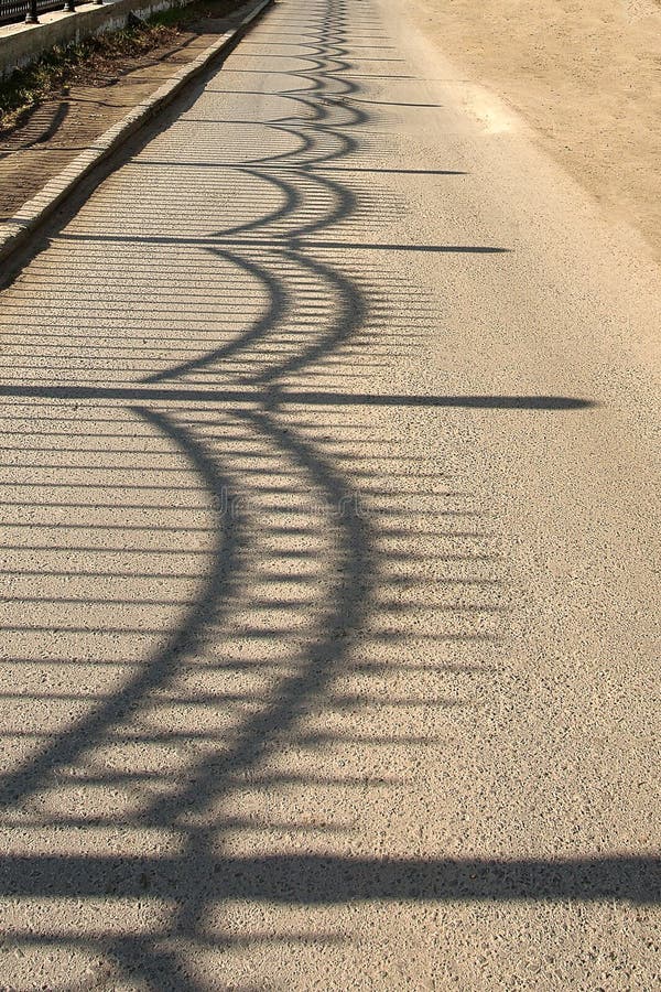 Pattern of Metal Fence Casting a Shadow on the Road Stock Image - Image ...
