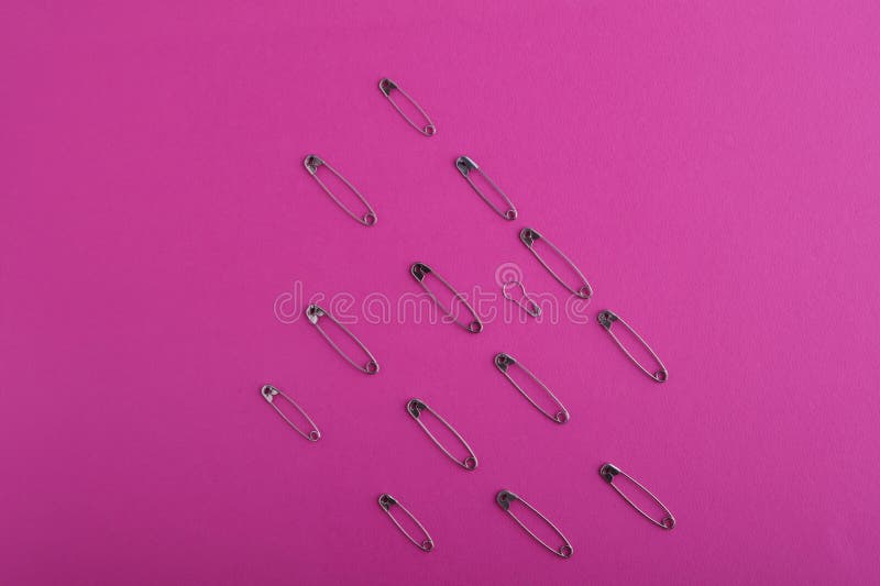 A Pattern of Silver Safety Pins of Different Sizes and Shapes Laid Out ...