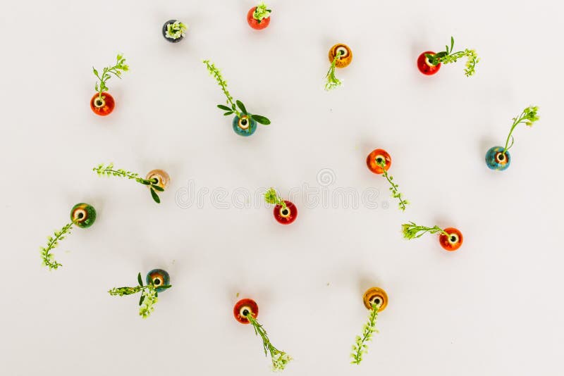 Small Multi-colored Ceramic Beads and Flowers on White Background ...