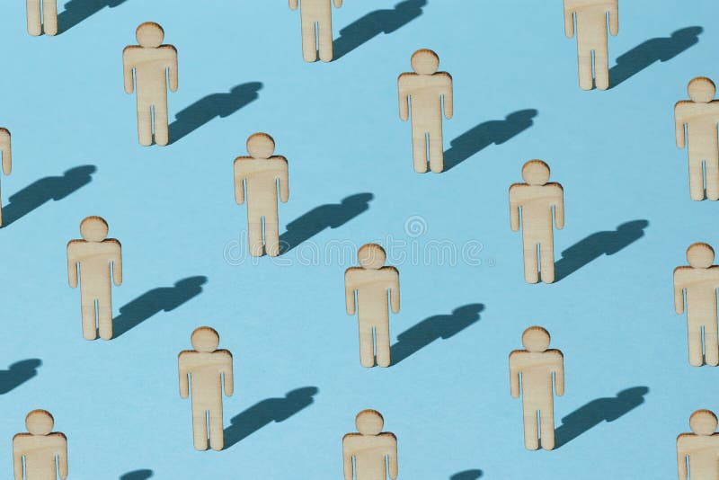 A Pattern of Wooden Male Figures in Bright Light on a Blue Background ...