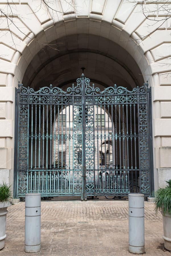 Patterned Metal Gate Made of Metal Rods. Arch in Stone Wall Stock Image ...