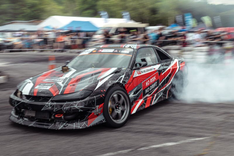 Patterned Race Car Emitting Heavy Smoke from the Engine during a Turn ...