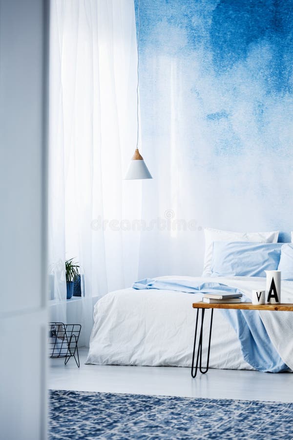 Patterned Rug in Modern, Pastel Blue Bedroom Interior with Bed a Stock ...