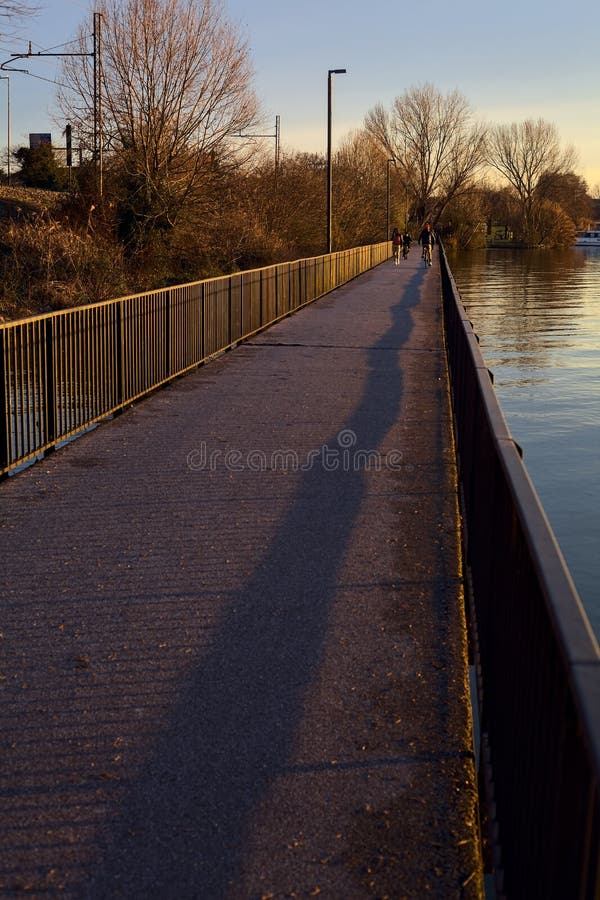 Paved Footbridge in a Park Over a Lake at Sunset Stock Photo - Image of ...