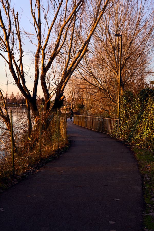 Paved Footbridge in a Park Over a Lake at Sunset Stock Photo - Image of ...