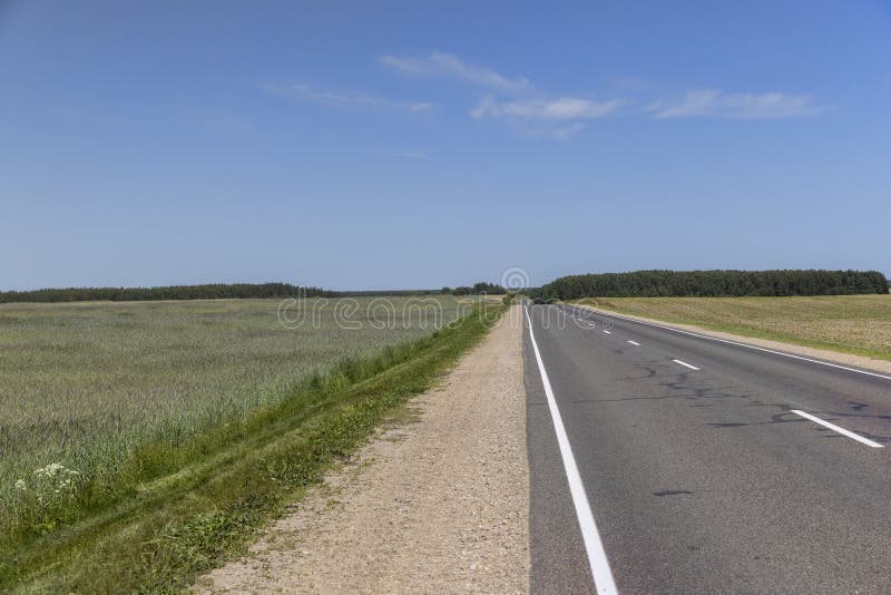 Paved Narrow Road in a Straight Line through the Field Stock Photo ...