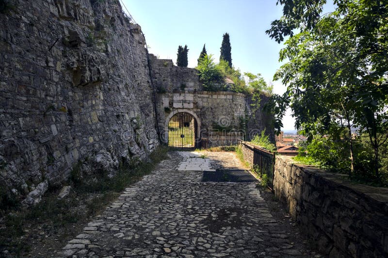 Paved Path that Leads To a Closed Gate and a Wall Stock Image - Image ...