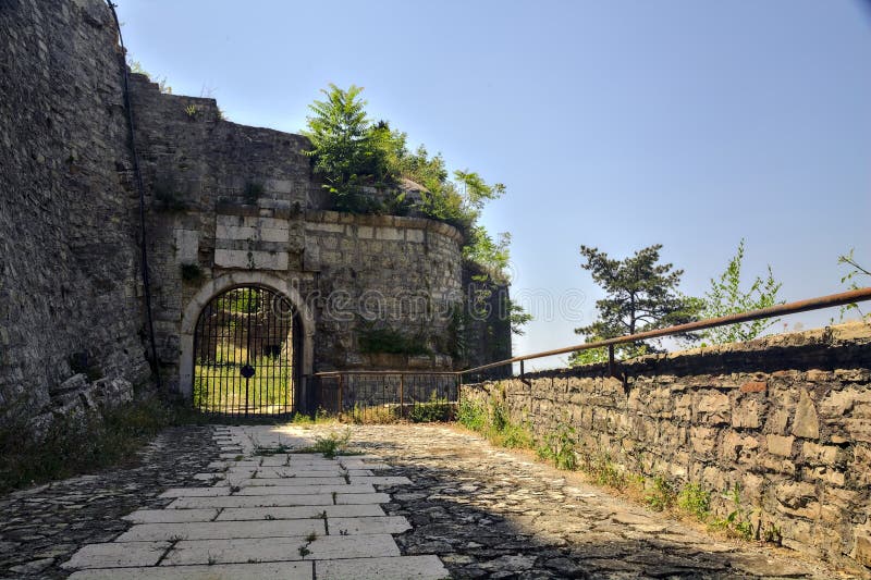 Paved Path that Leads To a Closed Gate and a Wall Stock Photo - Image ...