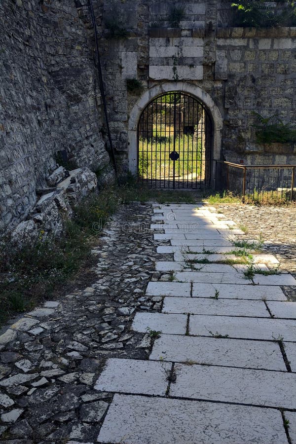 Paved Path that Leads To a Closed Gate and a Wall Stock Image - Image ...