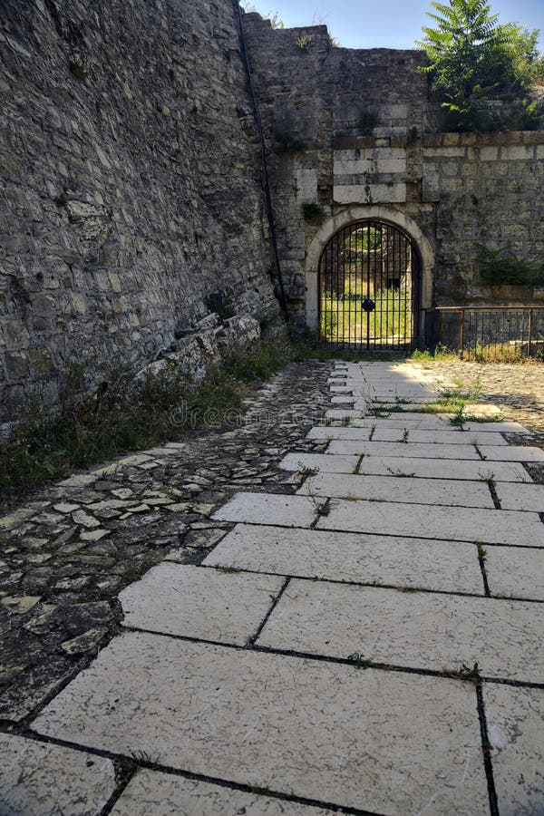 Paved Path that Leads To a Closed Gate and a Wall Stock Image - Image ...
