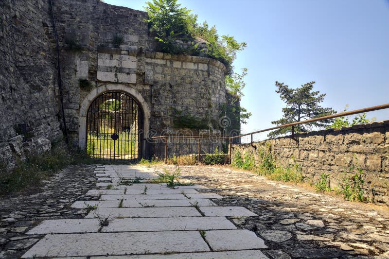 Paved Path that Leads To a Closed Gate and a Wall Stock Image - Image ...