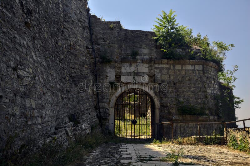 Paved Path that Leads To a Closed Gate and a Wall Stock Image - Image ...