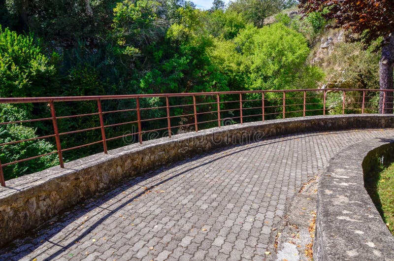 Paved Path with Railing in Park Setting Stock Image - Image of captures ...