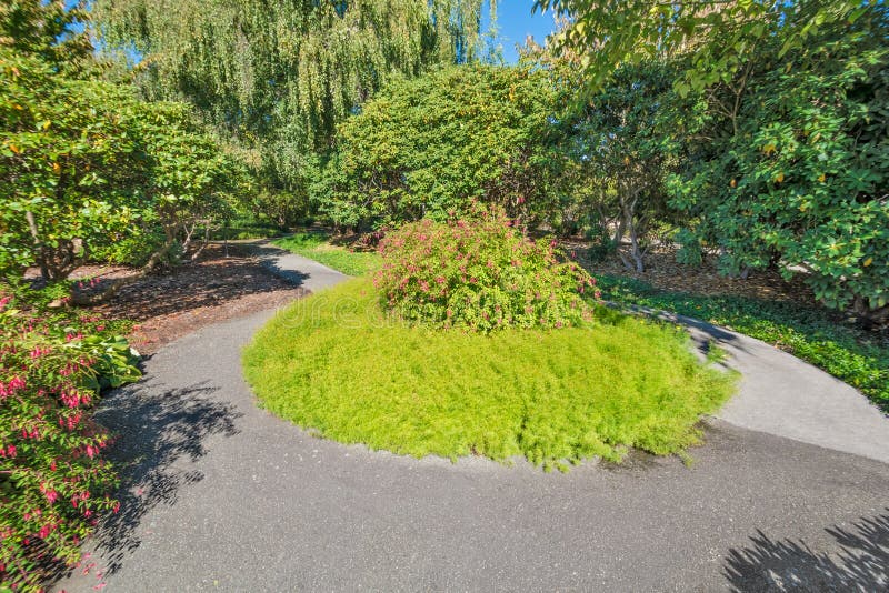 Paved Pathway through a Park with Round Flowerbed in the Middle Stock ...