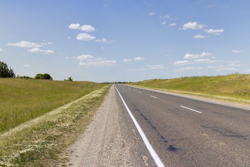 Paved Road Along and Blue Sky Stock Photo - Image of empty, hill: 378869220