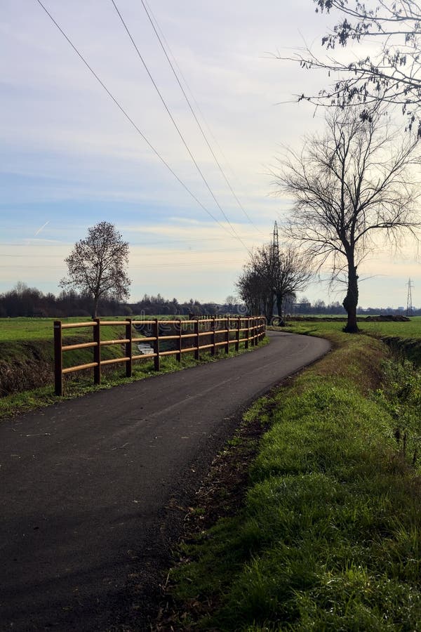 Paved Trail Bordered by a Railing and a Stream of Water between Fields ...