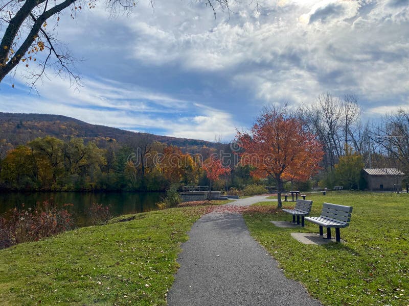 Paved Walkway with Benches and Lake on a Fall Day Stock Image - Image ...