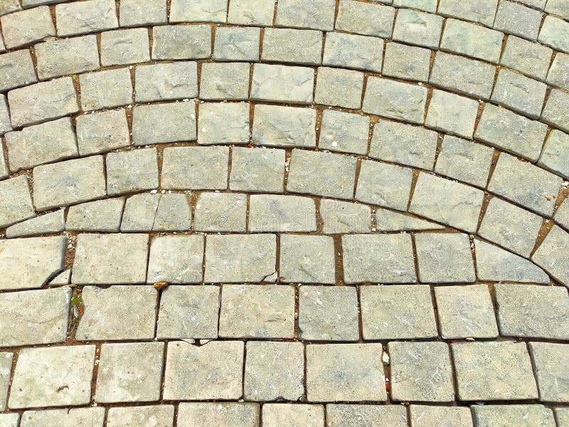 Paved Walkway with Curved Pattern and Textured Stone Blocks in a Serene ...