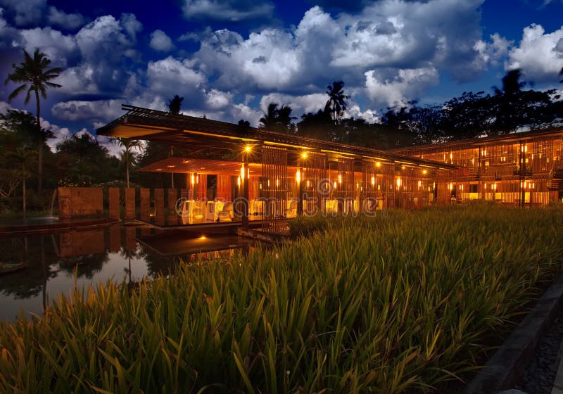 Pavilion with Night Illumination Behind Pool Stock Image - Image of ...