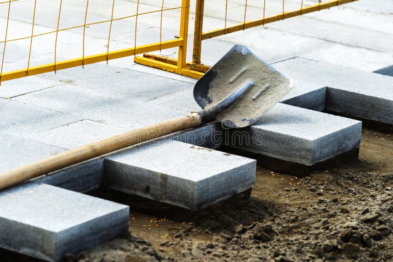 Paving the Footpath. Granite Blocks Laid on a Sandy Surface Stock Image ...