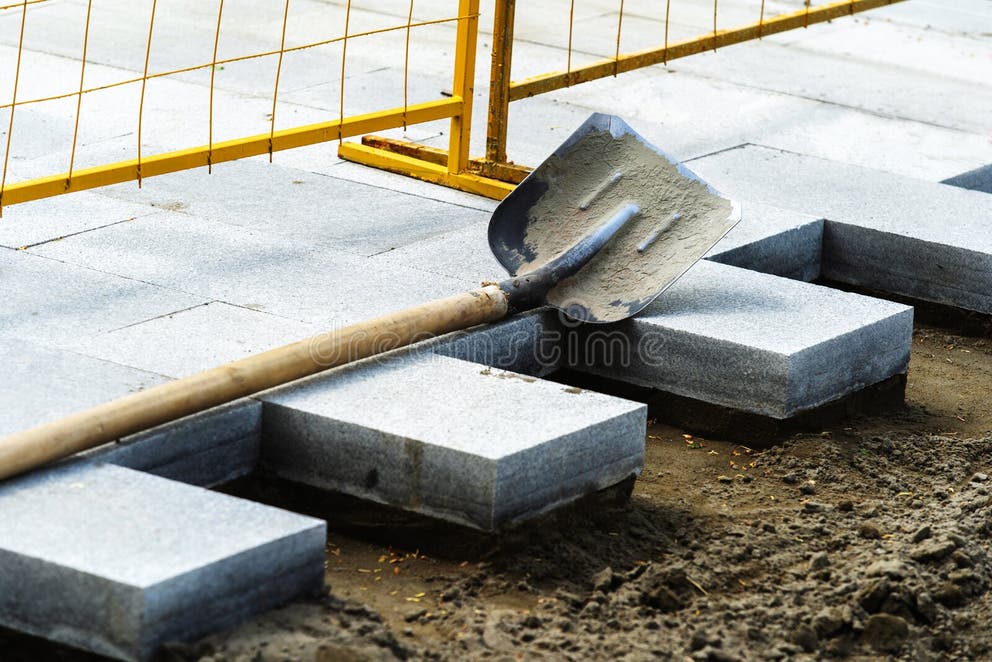 Paving the Footpath. Granite Blocks Laid on a Sandy Surface Stock Image ...