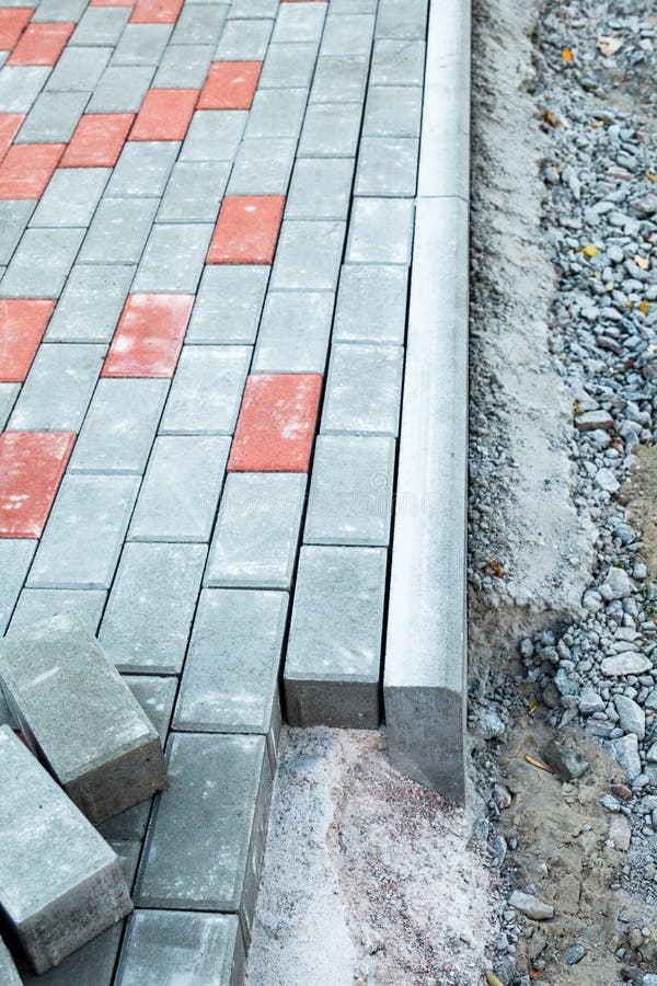 Paving the footpath stock photo. Image of laying, pavestone - 183944532