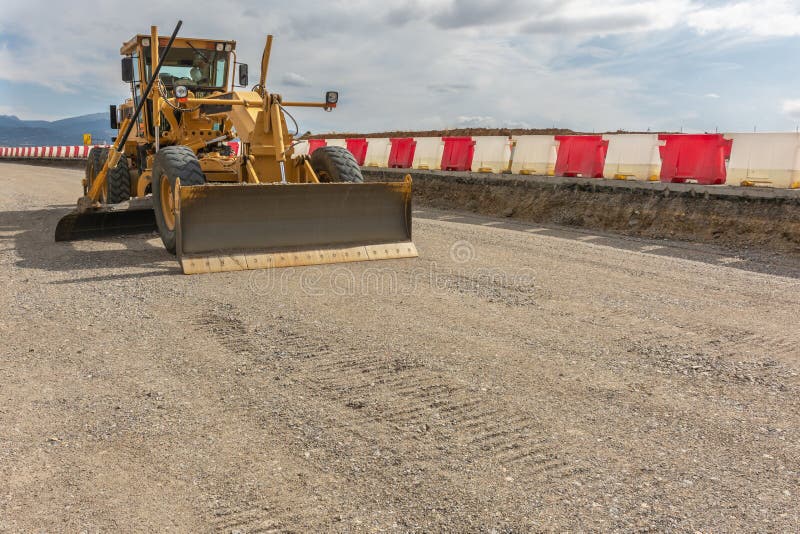 Paving the Ground at Road Construction Works with a Bulldozer Stock ...