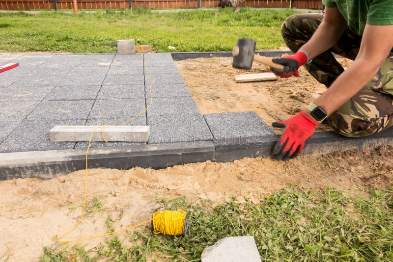 Paving a Pavement Made of Large Square Tiles Stock Photo - Image of ...