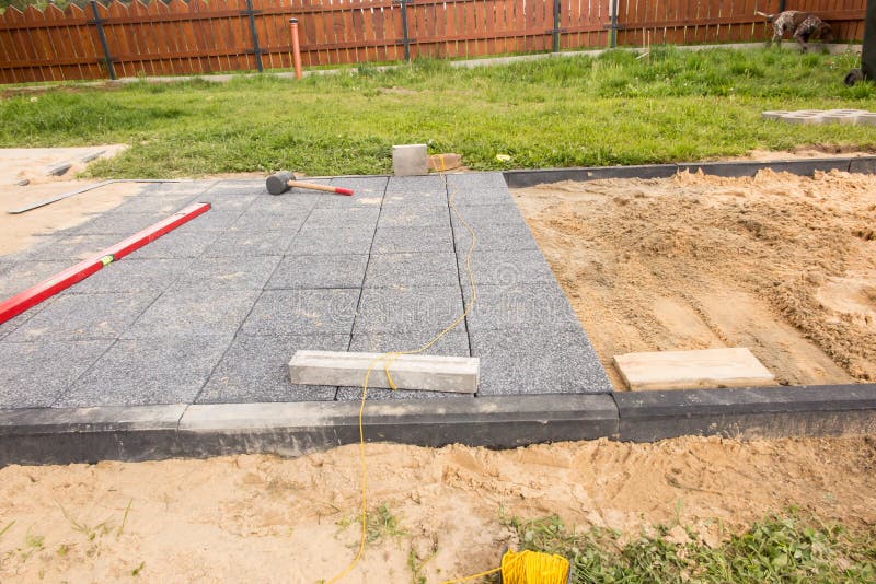 Paving a Pavement Made of Large Square Tiles Stock Photo - Image of ...