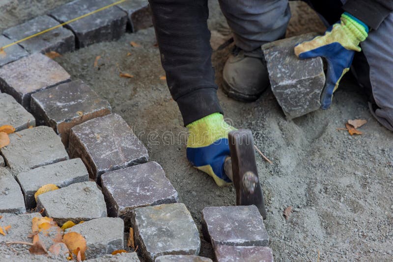 Paving Worker Using Hammer Pavement with Granite Stones Cobblestones ...