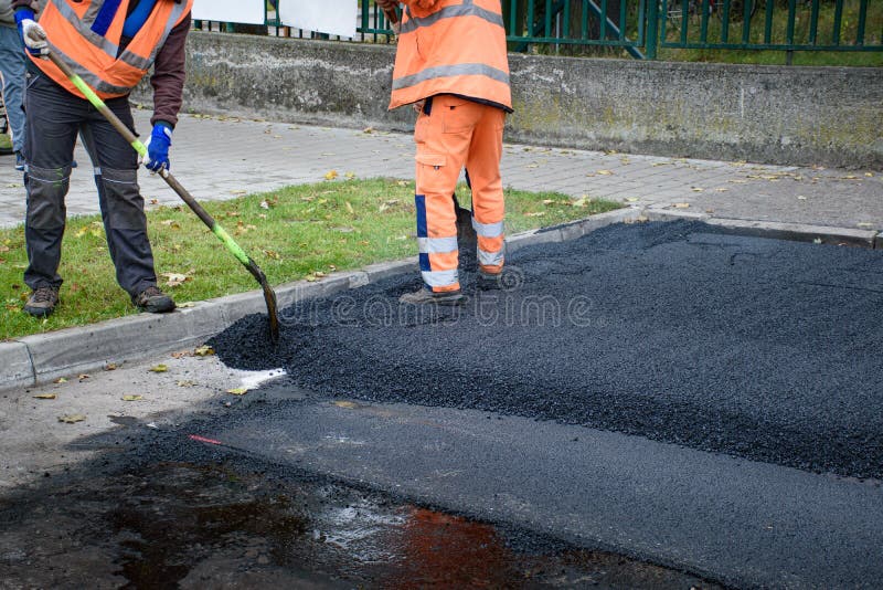 Paving Workers Adjust New Layer of Asphalt with Shovels in ...