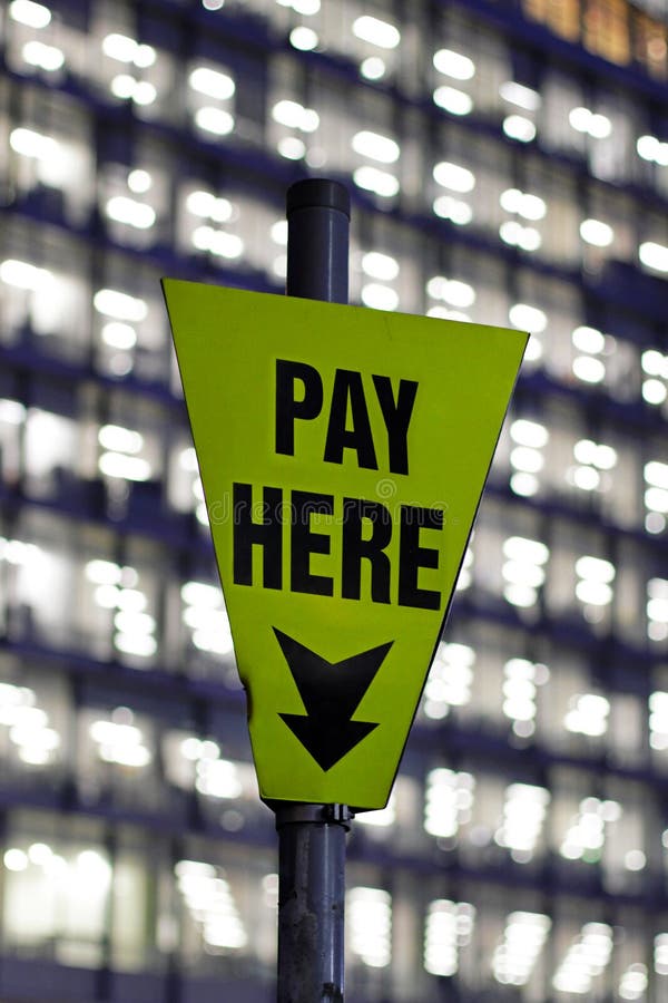 Yellow pay here signboard stock image. Image of symbol - 997335