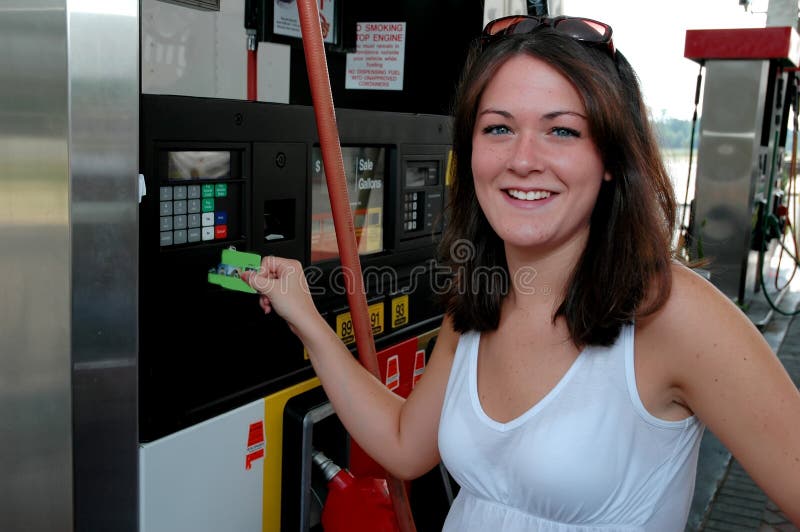 Pumping Gas - Happy stock photo. Image of attractive, striking - 997638
