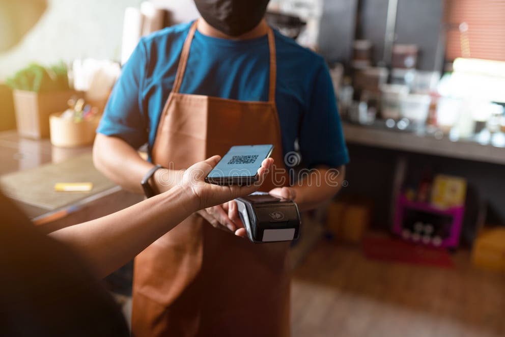 Paying with a QR Code at a Credit Card Machine in a Coffee Shop Stock ...