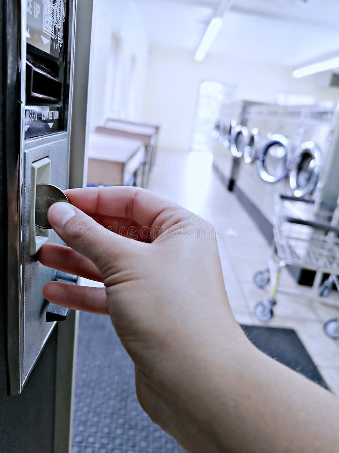 Paying with a Quarter Coin in a Machine at a Laundromat Stock Image ...