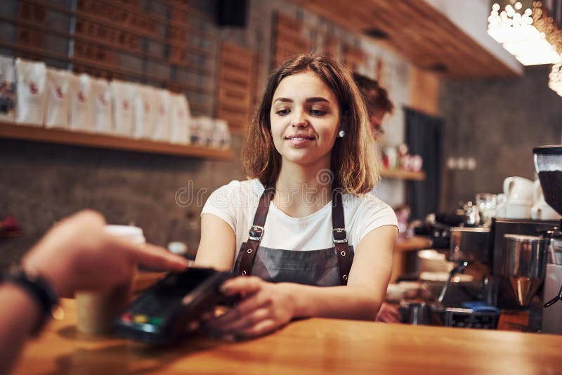 Paying by Using Digital System. Young Female Cafe Worker Indoors Stock ...