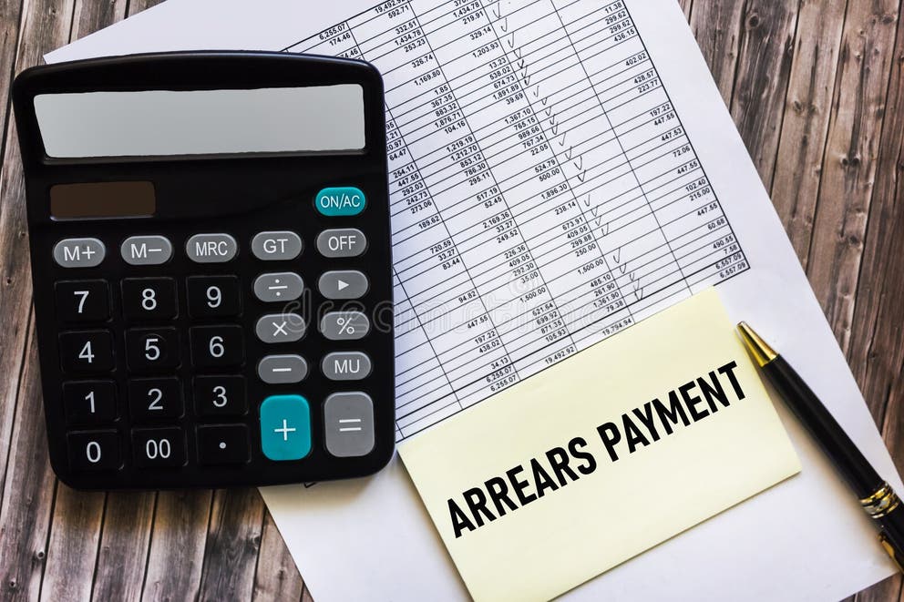 Payment Arrears are Written in a Notepad, on a Wooden Table with a ...