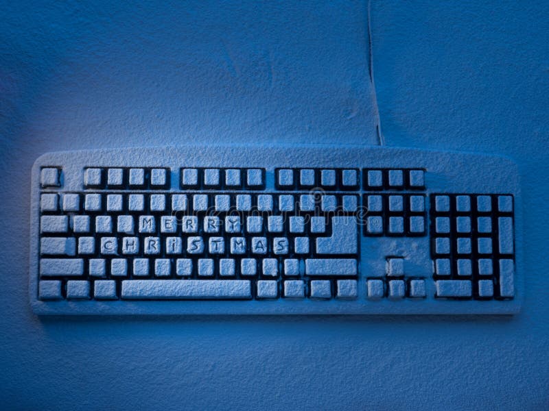 PC Keyboard Covered with Snow Illuminated by Blue Neon Light with ...