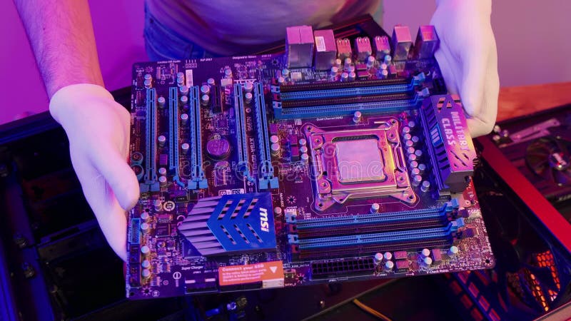 PC Technician Serves Modern Motherboard Close Up. Upgrading Computer ...