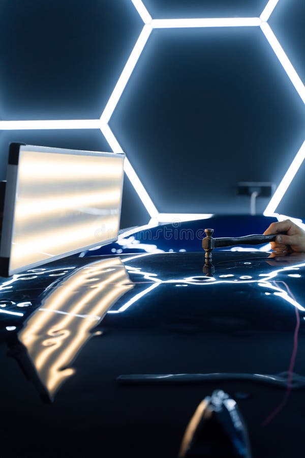 PDR Technician Pulls a Dent from the Car Panel Using Glue Tabs and a ...