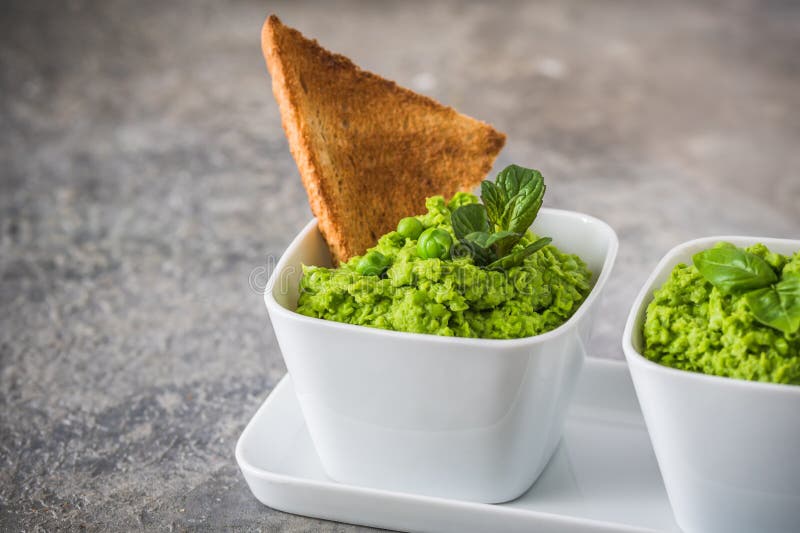 Pea Puree with Basil and Roasted Bread on Rustic Gray Background Stock ...