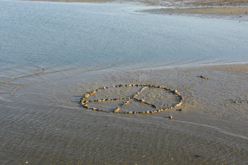 Peace Symbol Made Out of Rocks in Shallow Water Stock Image - Image of ...