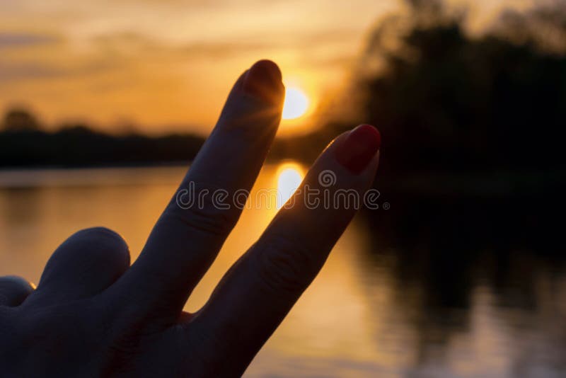Peace sign at sunset stock photo. Image of golden, water - 117072540