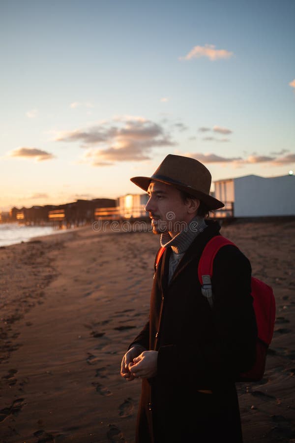 Peaceful Beach Scene with Man Walking at Sunset. Stock Image - Image of ...