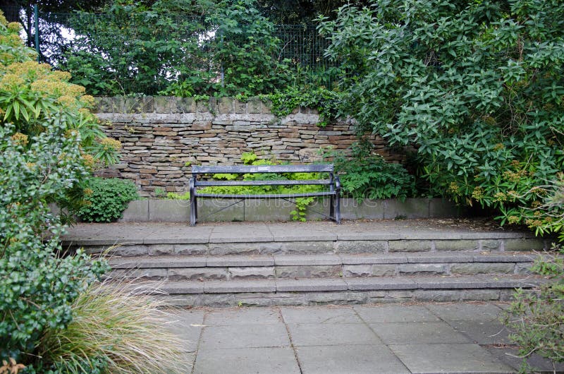 Peaceful bench in a garden stock image. Image of stone - 278984713