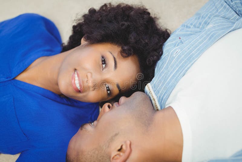 Peaceful Couple Lying on the Floor Stock Photo - Image of black ...
